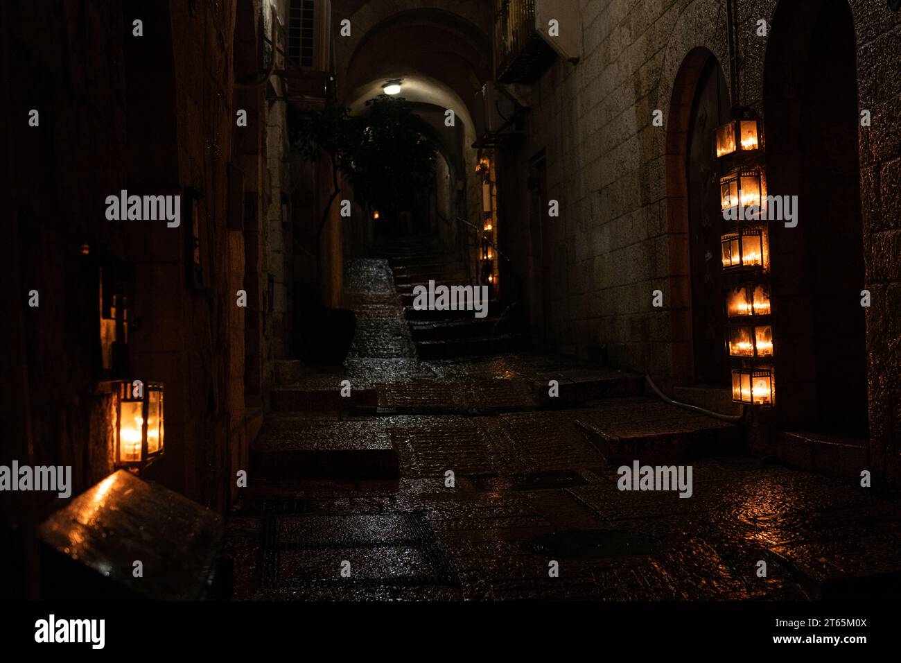 Burning Hanukkah candles cast a glow on the cobblestone streets of the ...