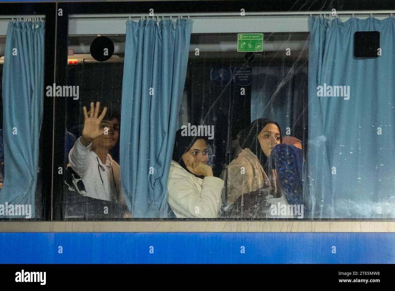 People evacuated from Gaza sit on a bus after arriving by plane from ...