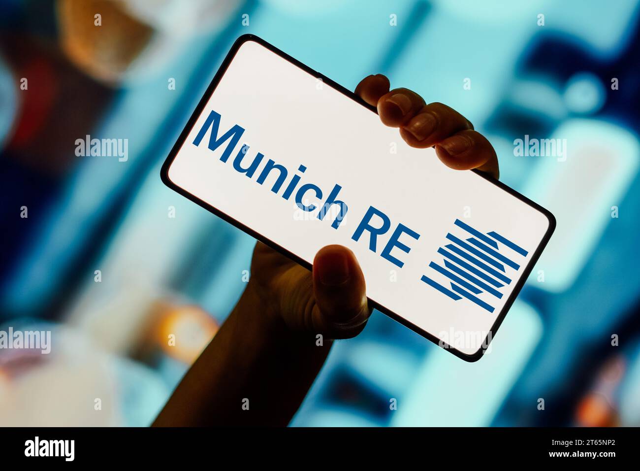 In this photo illustration, the Munich Re logo is displayed on a ...