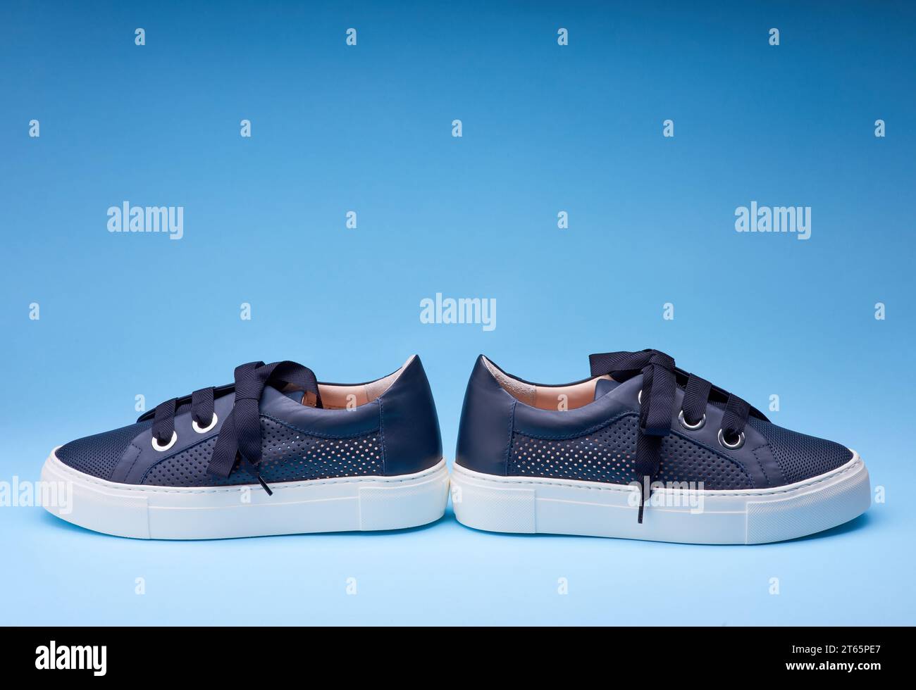Modern casual navy blue sneakers from perforated leather placed back to ...