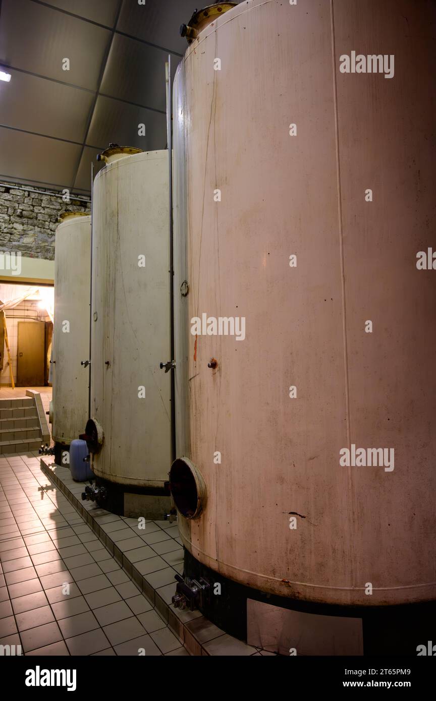 Concrete tanks for fermentation process. Visit of undergrounds caves ...