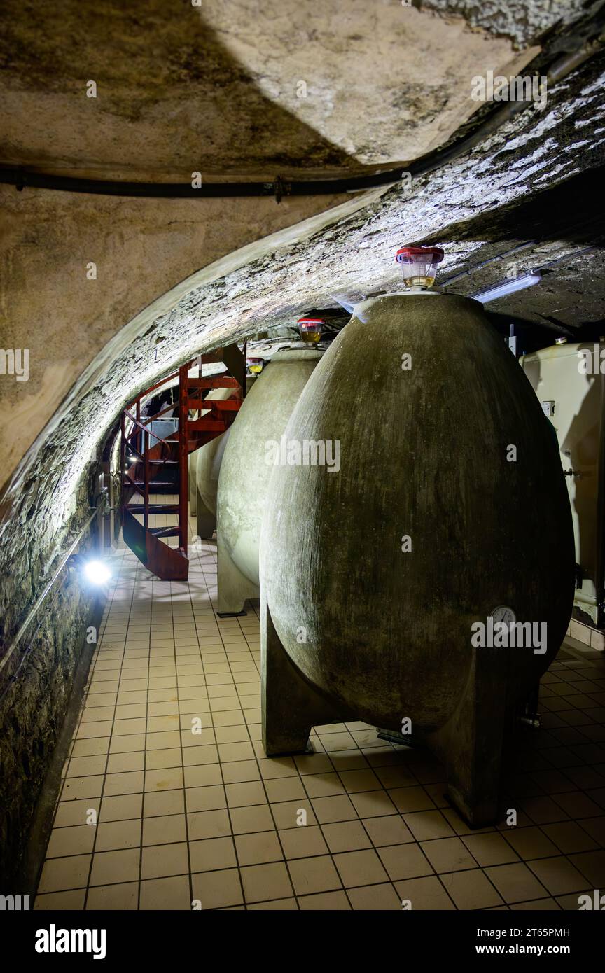 Concrete tanks eggs for fermentation process. Visit of undergrounds ...