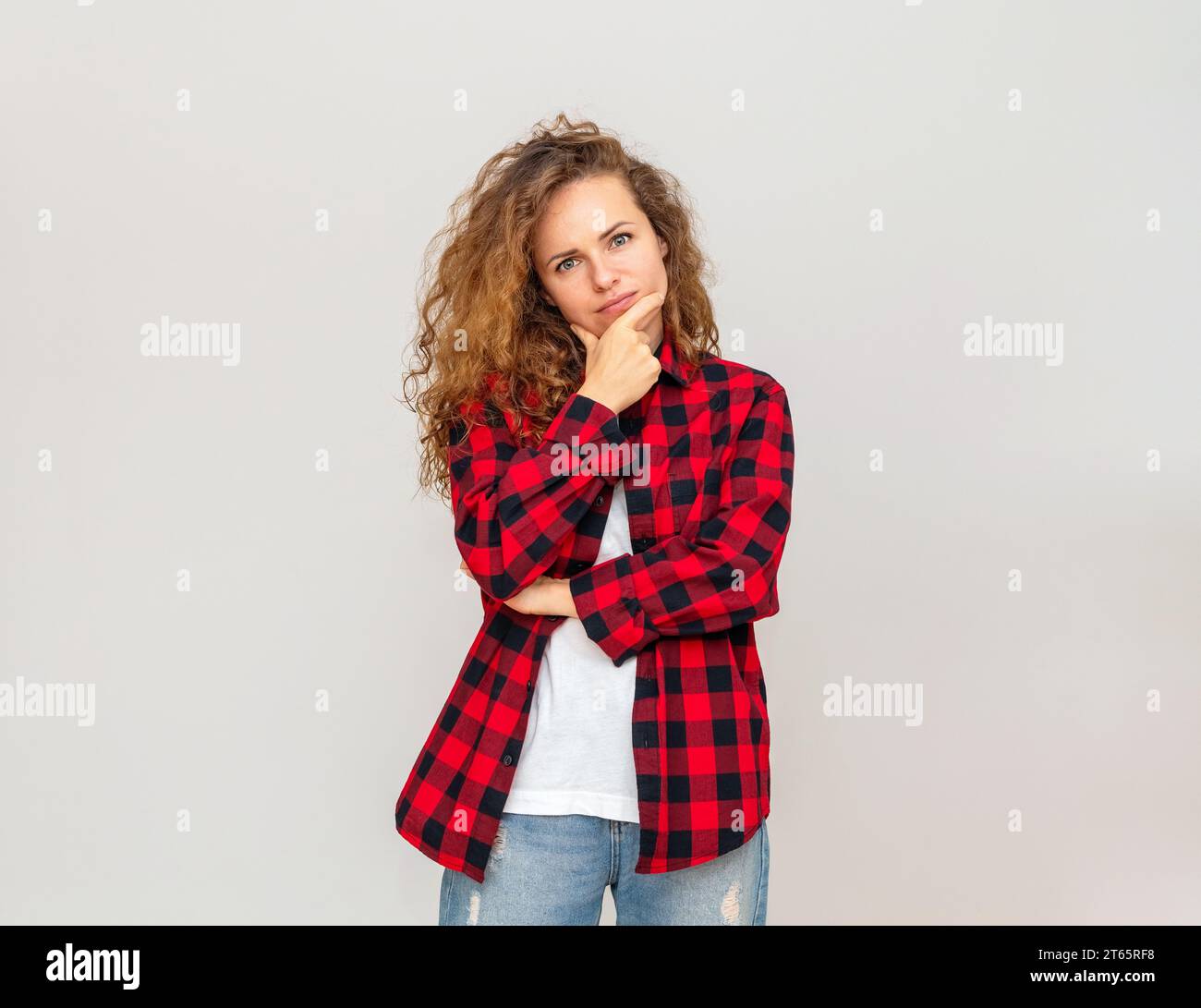 Female person thinking touching her chin with her hand in front of ...