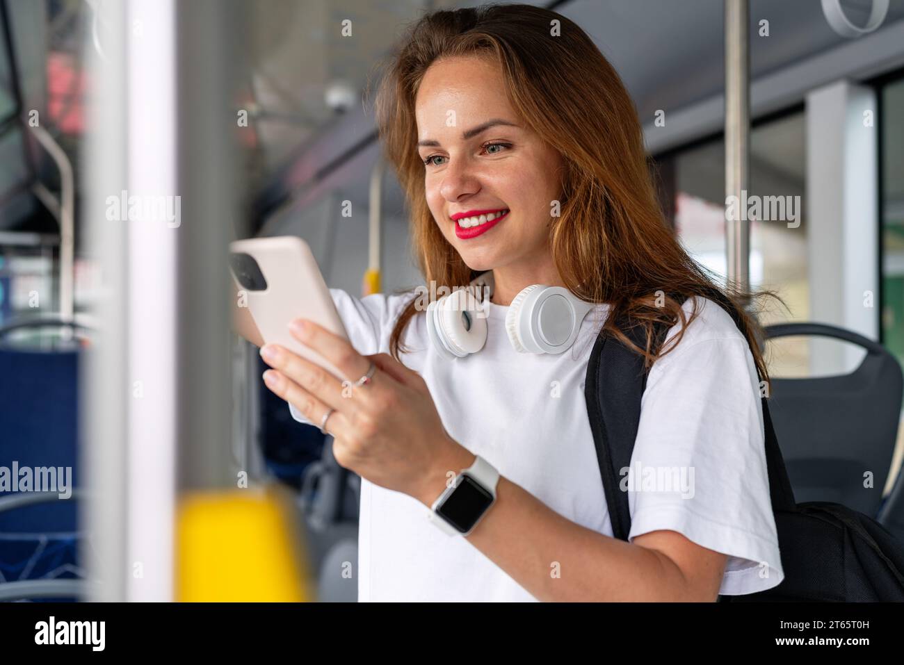 Urban woman using her smartphone while traveling shuttle bus. Using ...