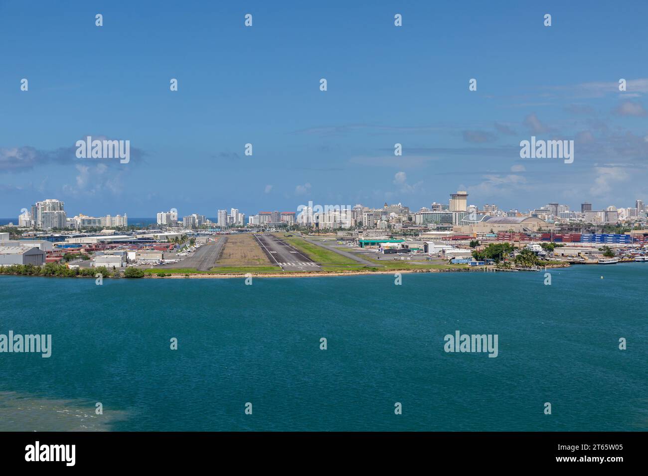 City skyline behind the Fernando Luis Ribas Dominicci airport runway in ...