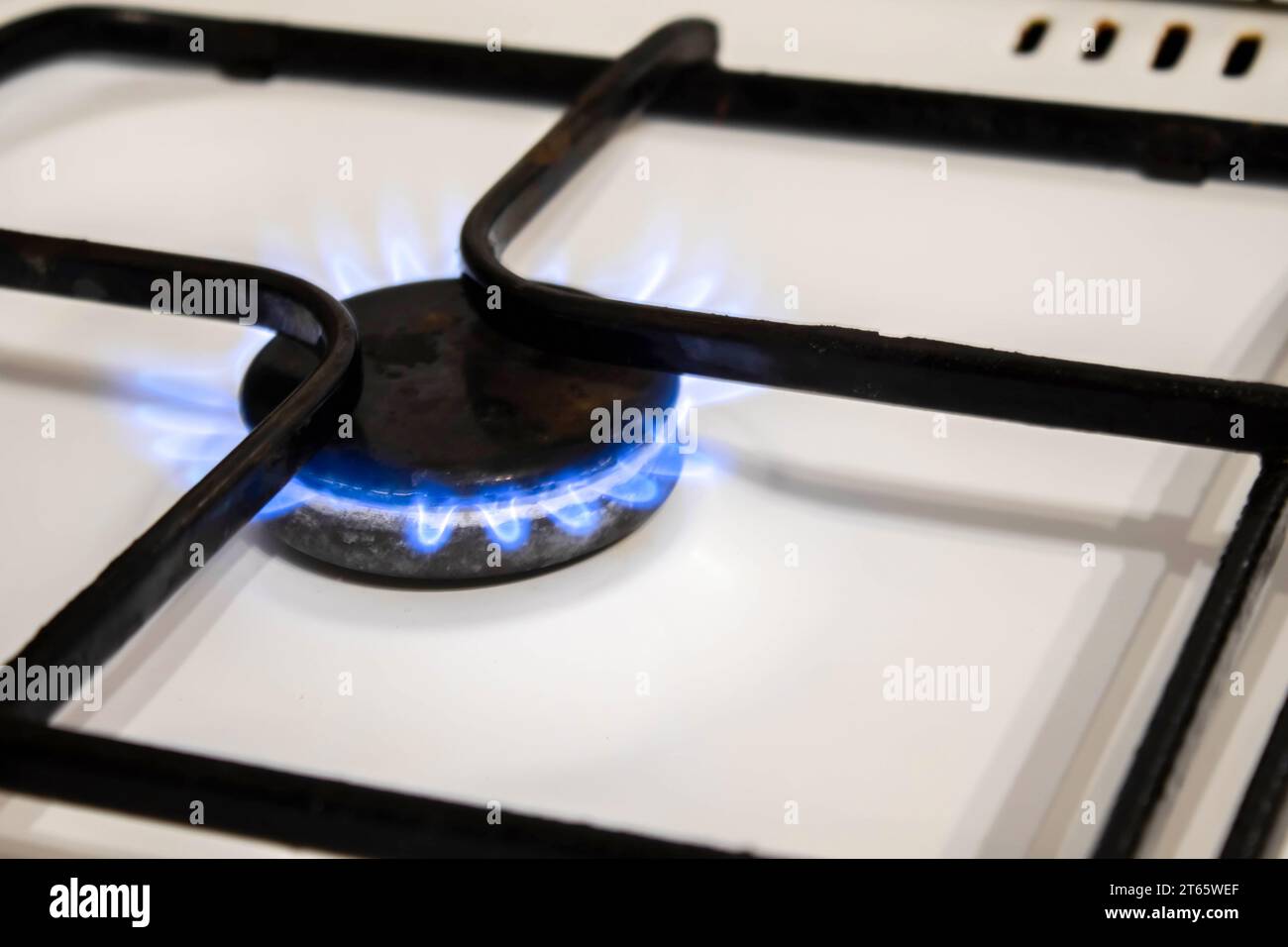 Burning burner of an old gas stove at home.Blue burning gas (methane ...