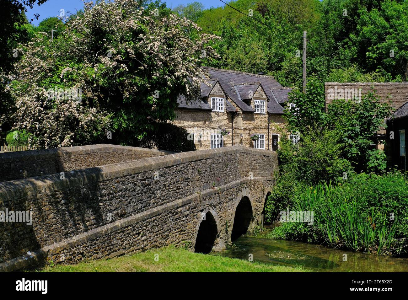 Ford: Old bridge over By Brook with White Hart pub and blossom at Ford ...