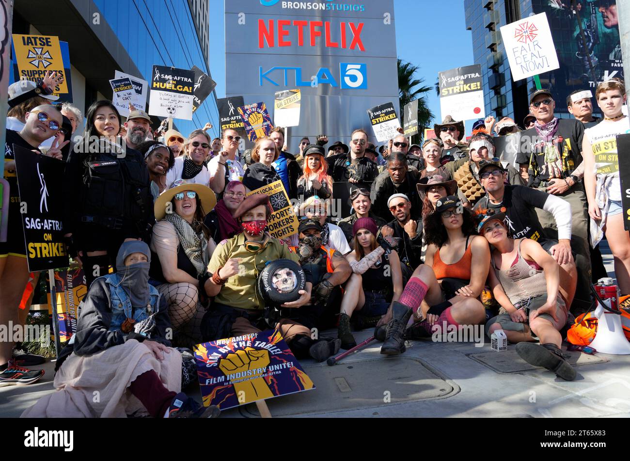 Striking SAG-AFTRA members pose for a group photo on a post apocalyptic ...