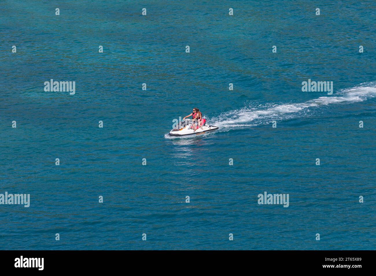 Cruise ship passengers playing on jet skis near the pier on Royal ...