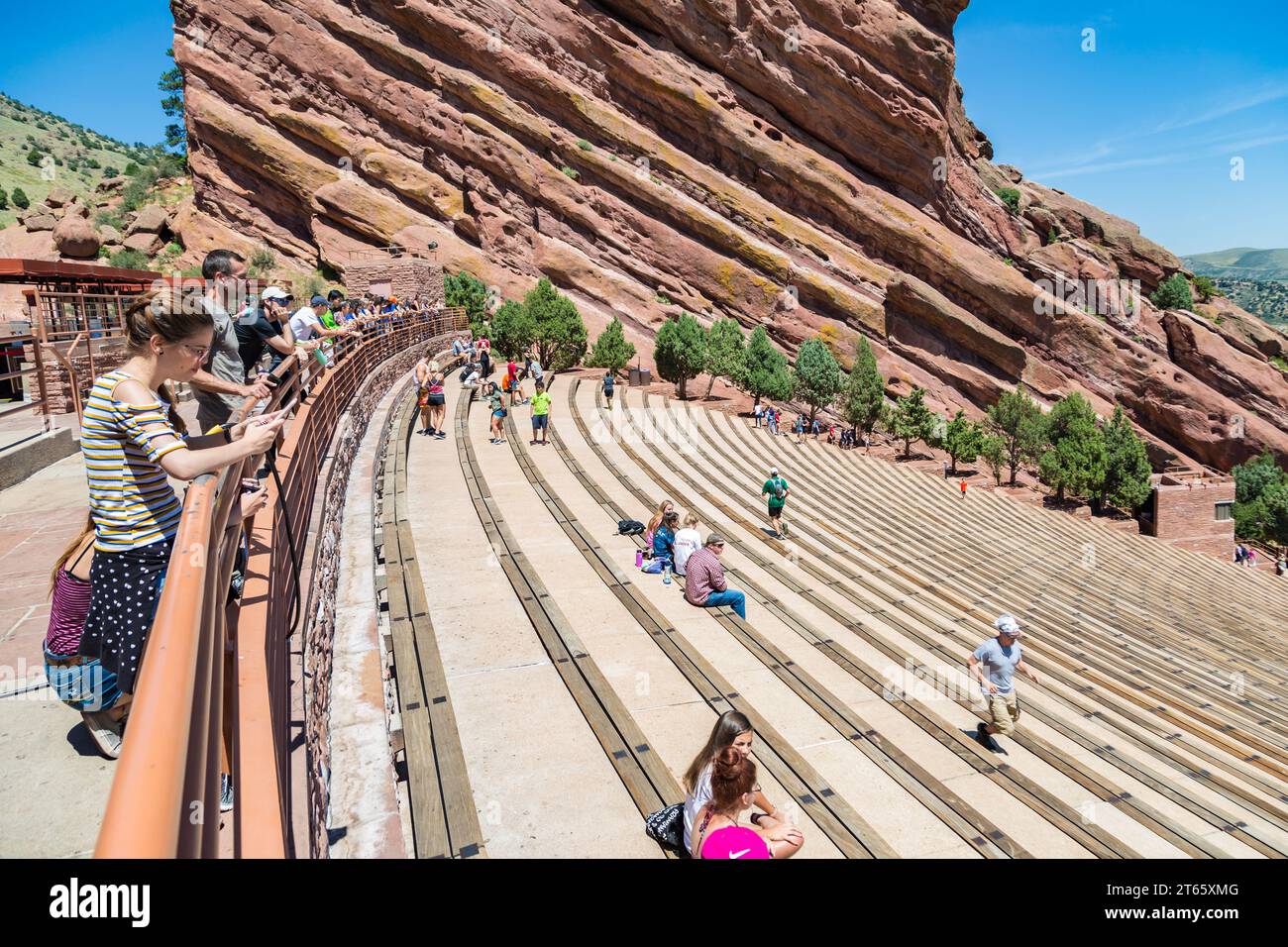 Visitors sit looking down onto stage from near the top of expansive Red ...
