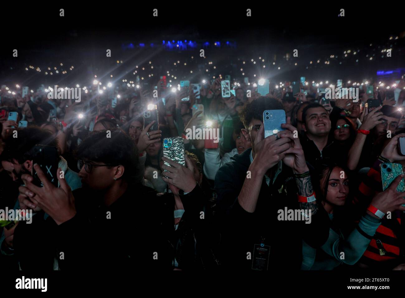 Dozens of people photograph, record and light up a performance by ...