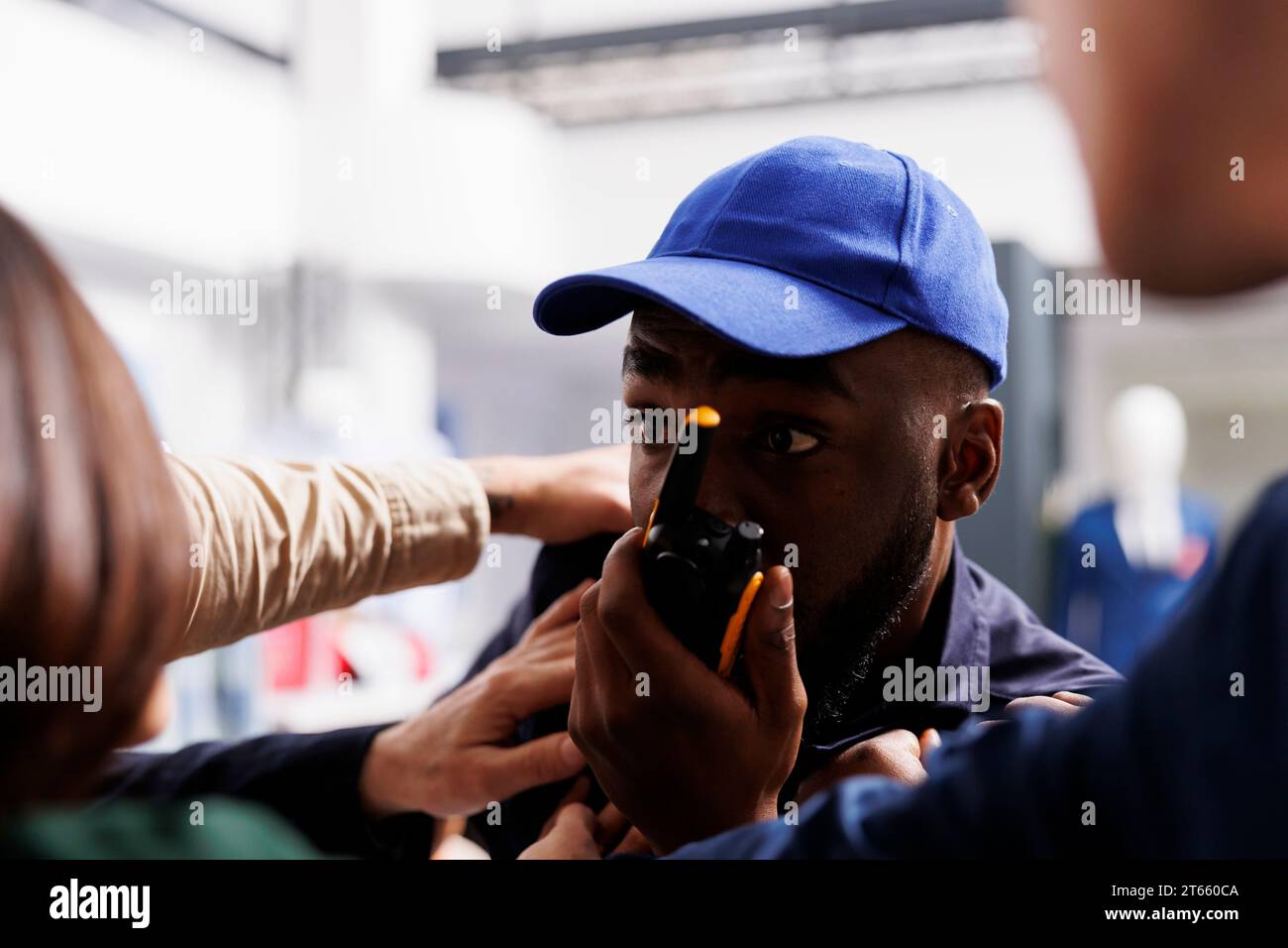 African American man security guy using walkie-talkie while holding ...