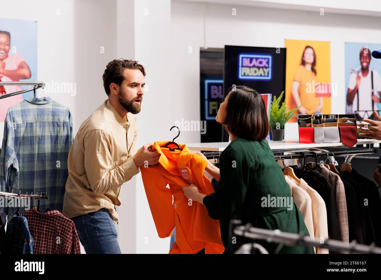 Angry mad man and woman shoppers arguing in clothing store. Aggressive ...