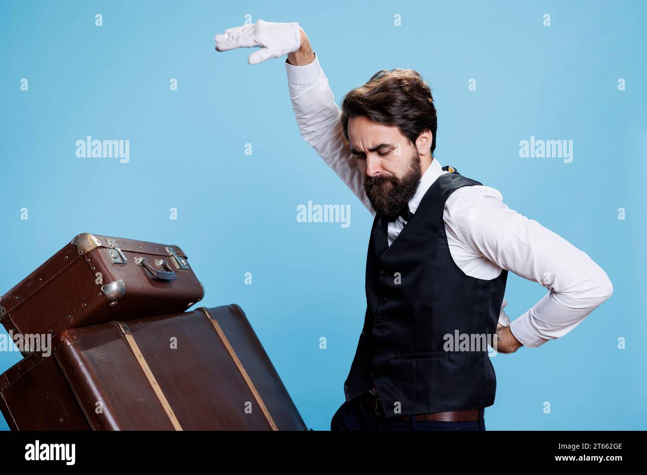 Cheerful porter having fun in studio and showing confidence with crazy ...