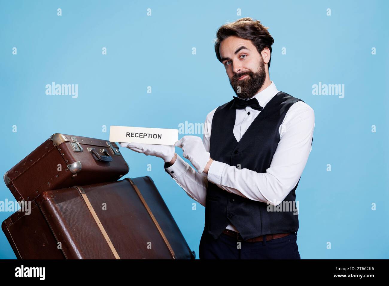 Bellhop shows reception indicator on camera, pointing guests in the ...
