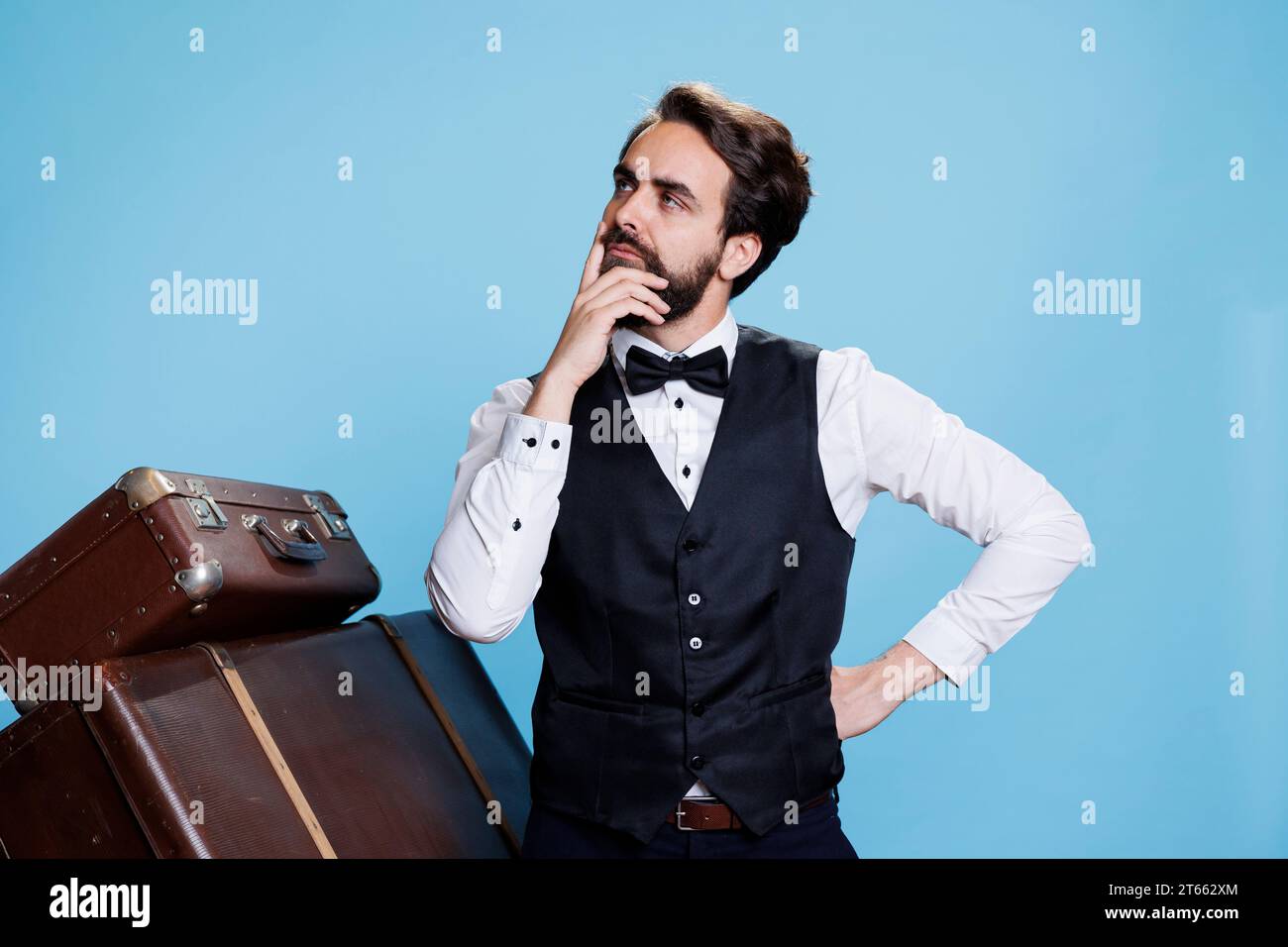 Hotel porter acts reflective in studio, thinking about something while ...