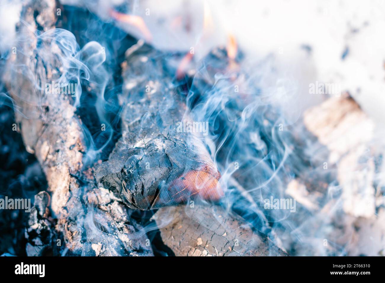 Very close up view at small bonfire fired right on snow surface, hot ...