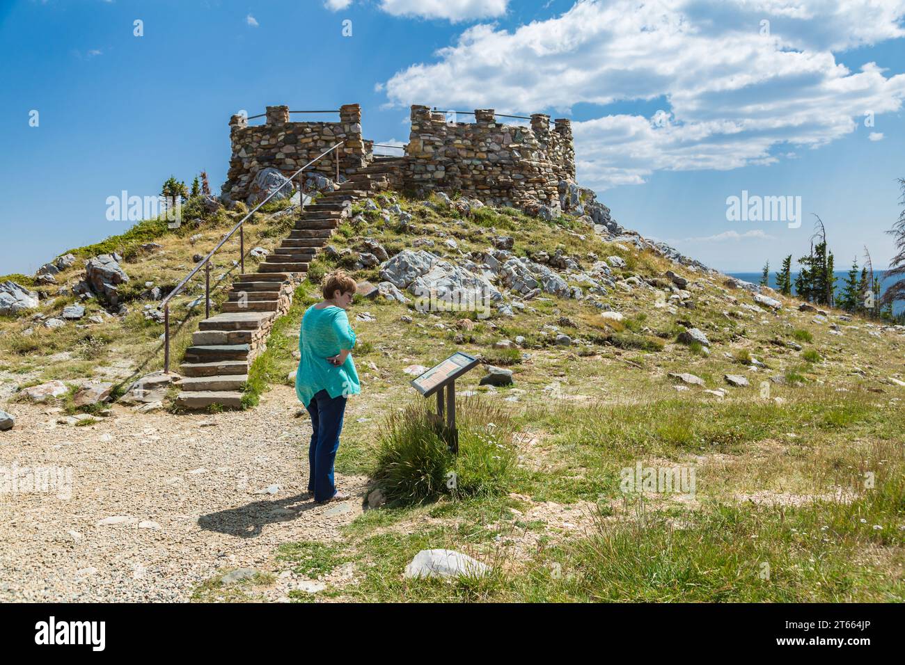 Woman reading informational sign at the Libby Flats Observation area in ...