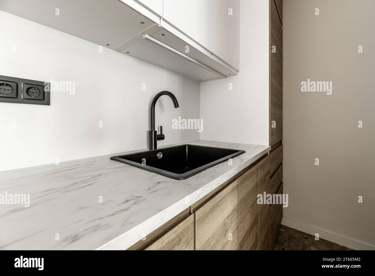 Open kitchen of a loft-type home with oak wood furniture, black resin ...