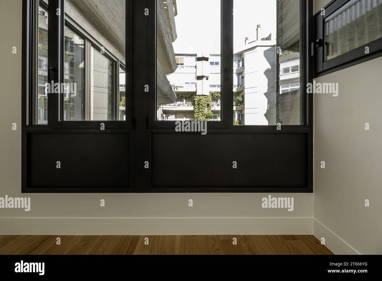 Closed terrace of a residential house with wooden and black metal ...