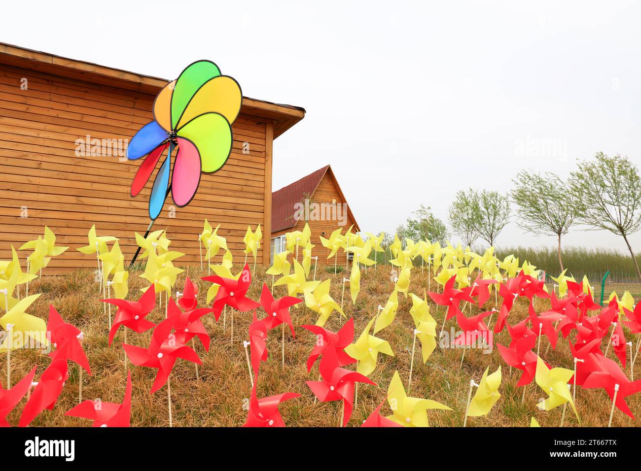 Colored windmills and wooden houses in the park Stock Photo - Alamy