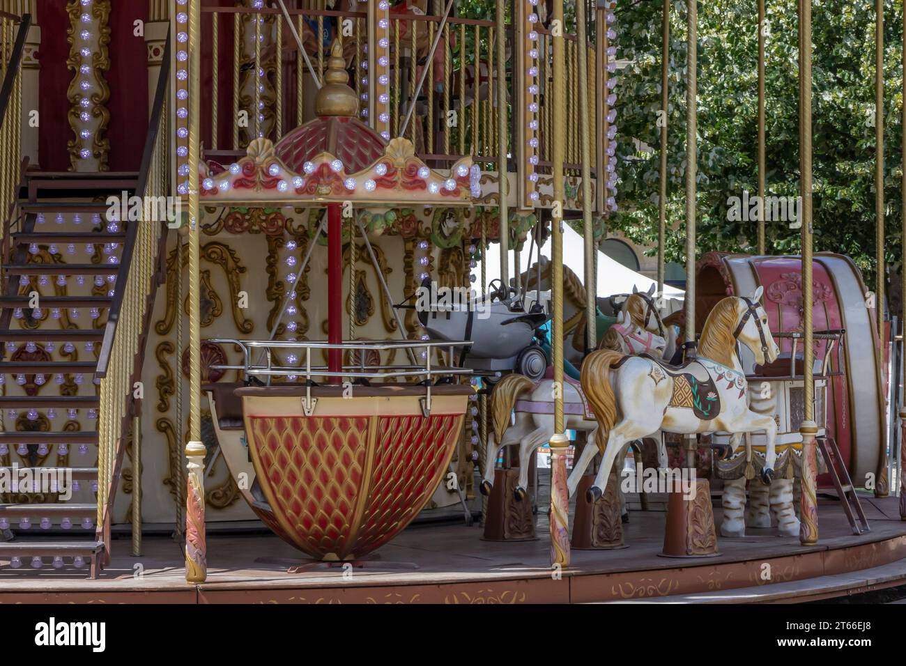 Old fashioned merry-go-round lite up with no one onboard Stock Photo ...