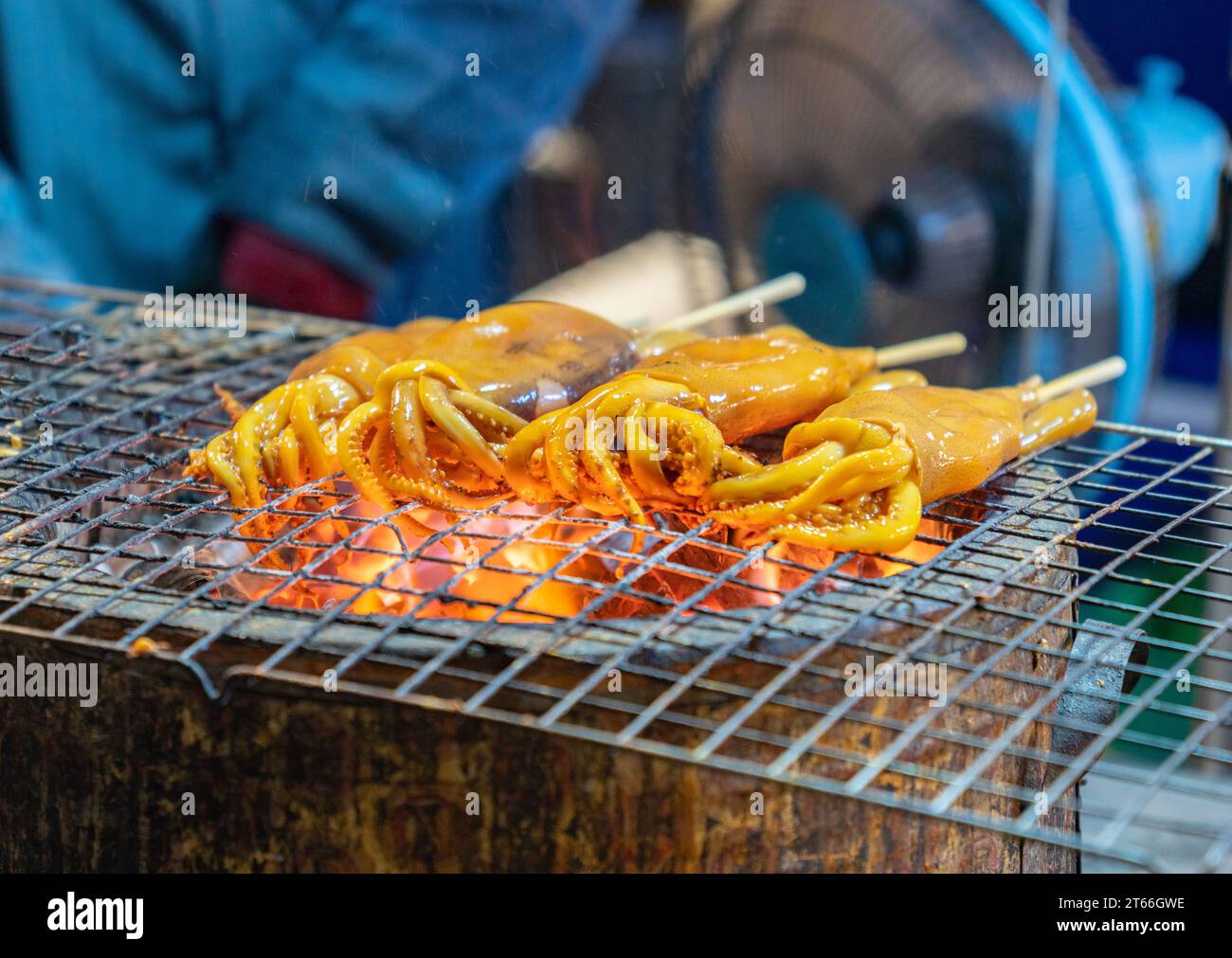 Grilled squid on a charcoal stove at street food Stock Photo - Alamy