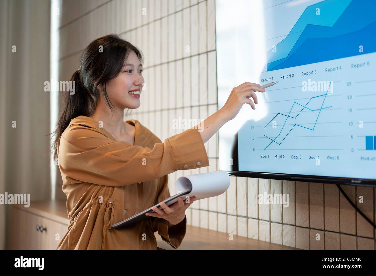 A smart and attractive Asian businesswoman or female financial analyst ...