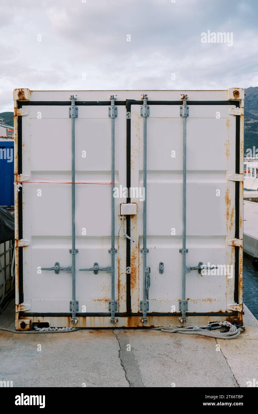 White metal shipping container stands on a pier by the sea Stock Photo ...