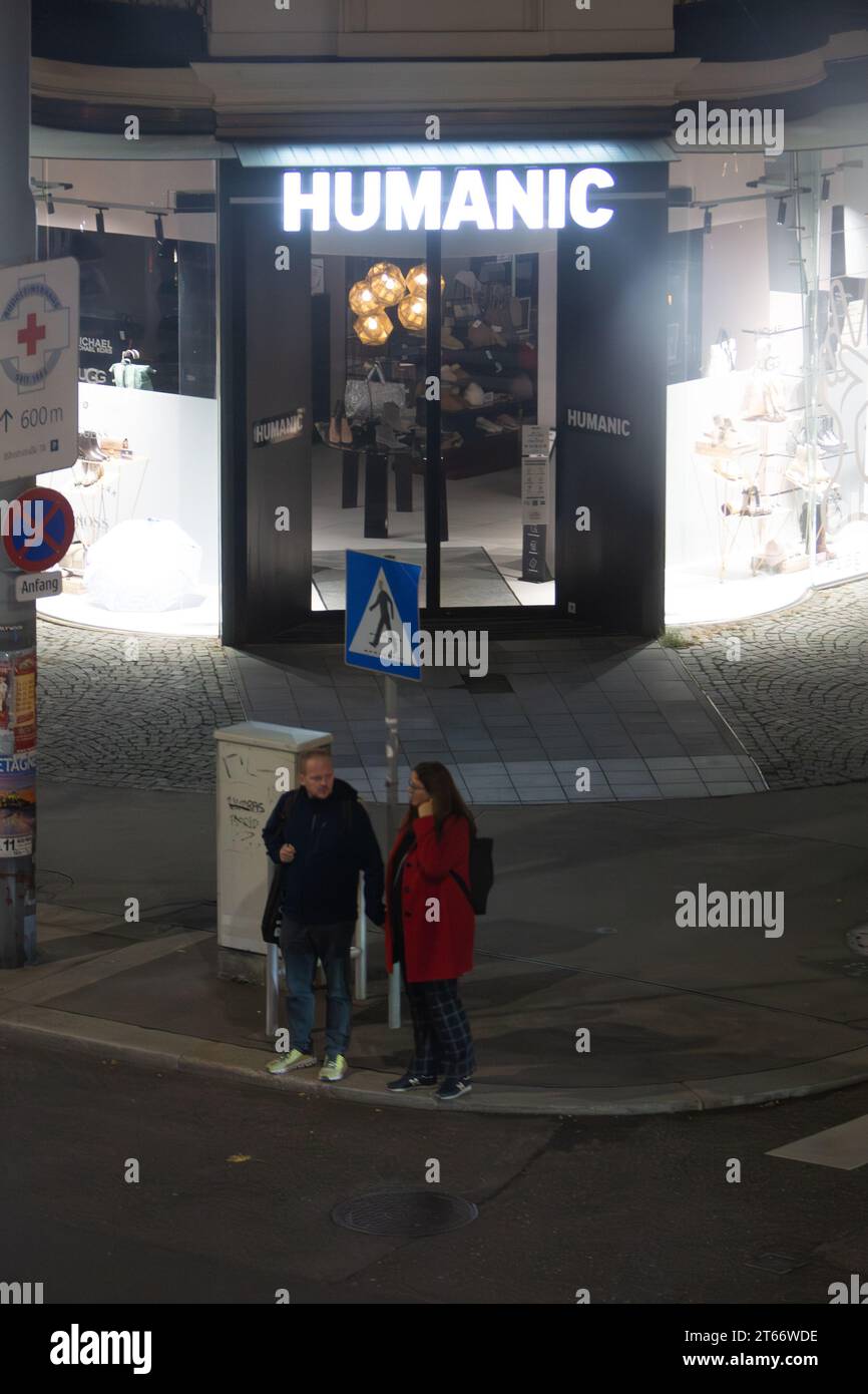 A couple of man and women walks in front of the Humanic store, Vienna ...