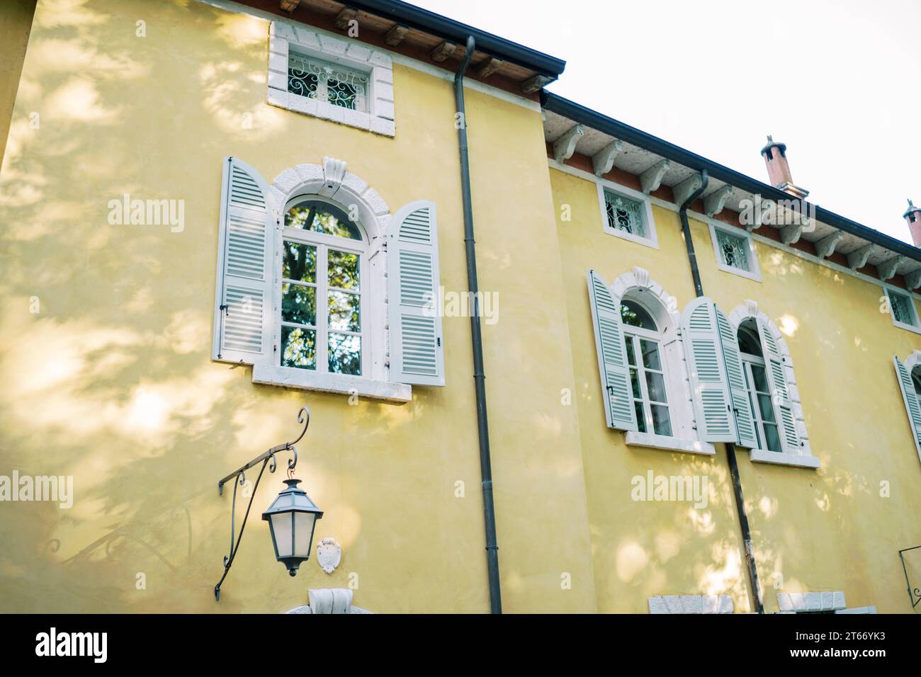Rectangular small barred windows under the roof of an old mansion Stock ...