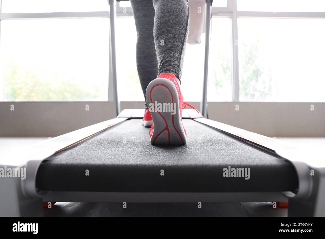 Woman running on treadmill in gym, closeup of legs Stock Photo - Alamy