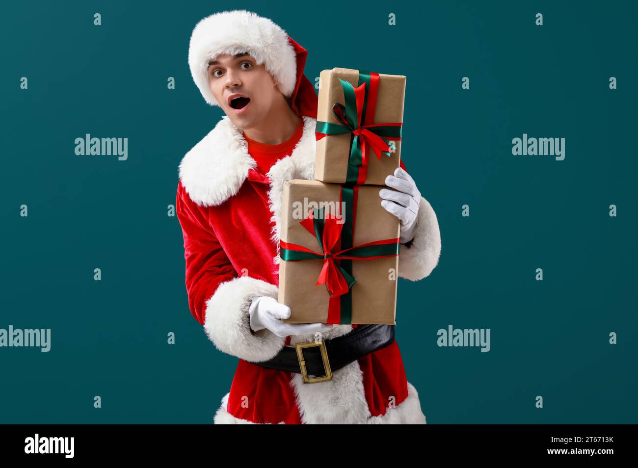 Shocked Santa Claus with gift boxes on dark green background Stock ...