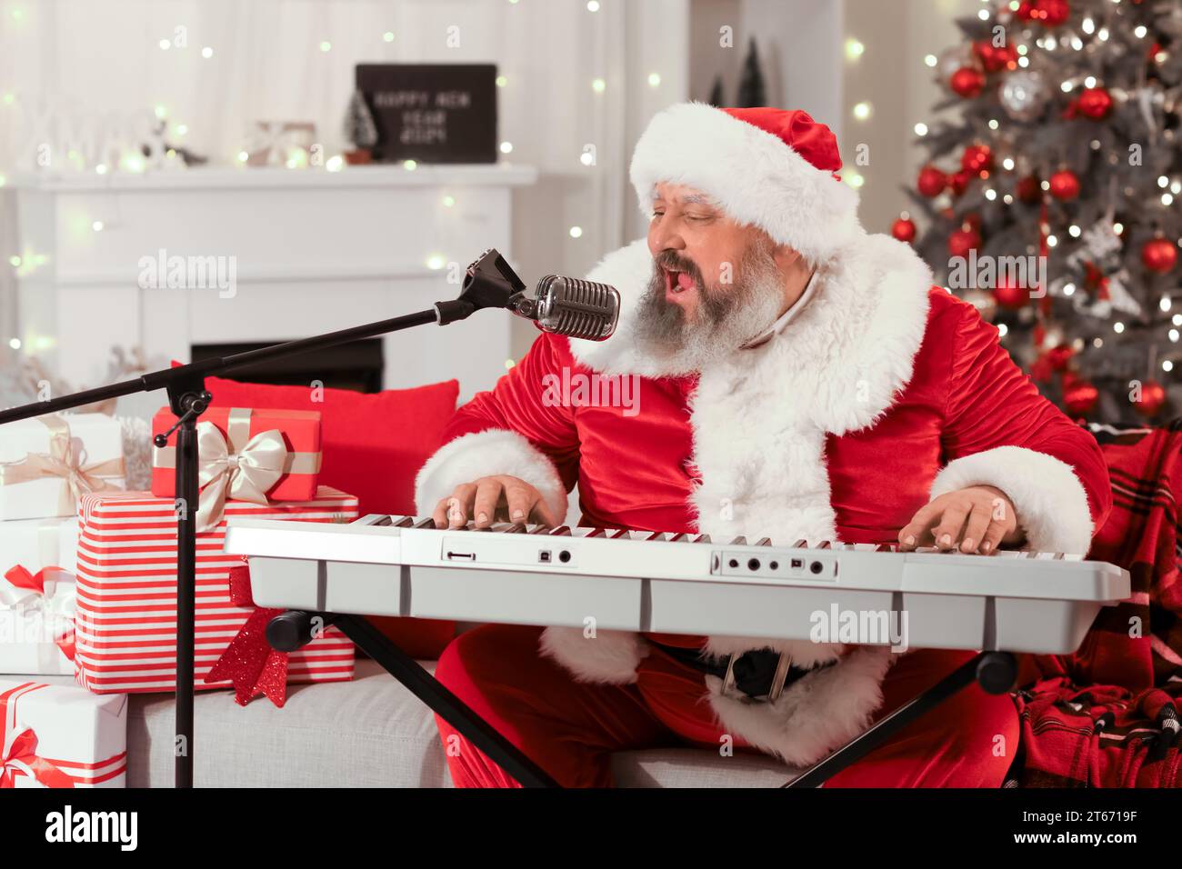 Santa Claus playing synthesizer at home on Christmas eve Stock Photo ...