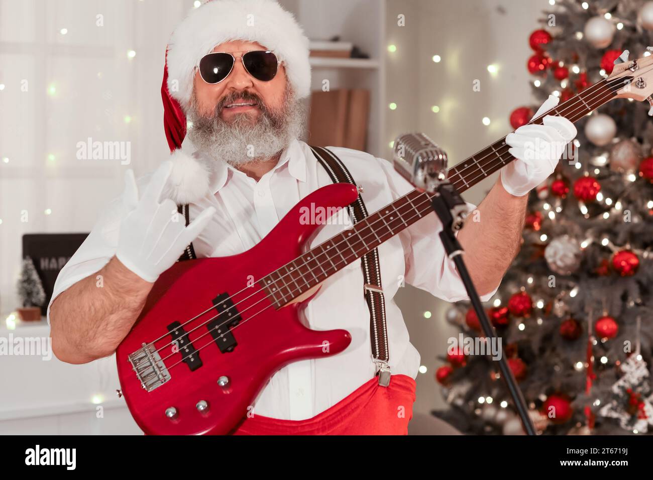 Cool Santa Claus playing guitar at home on Christmas eve Stock Photo ...
