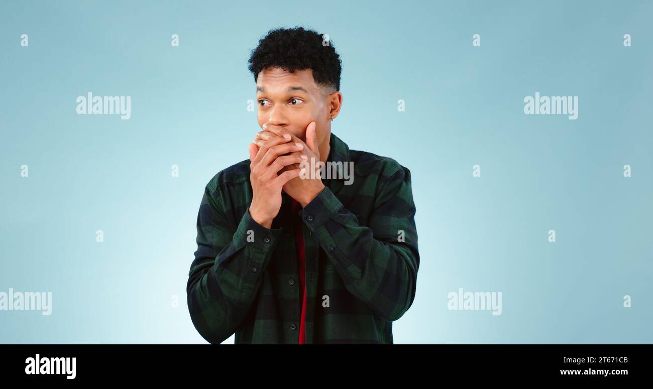 Wow, surprise and hands on face of man in studio with shocking, news or ...