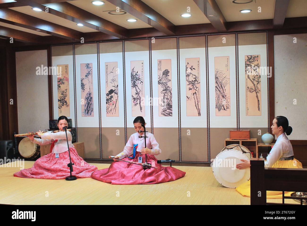 Costumed women play traditional musical instruments at the Korea ...