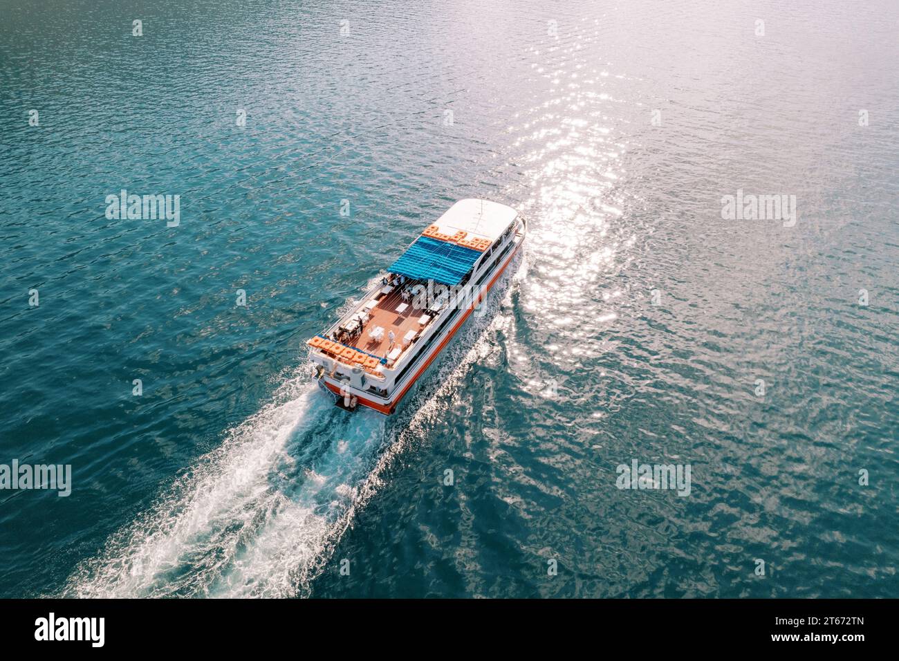 Double-decker excursion ship sails on the blue sea. Top view Stock ...