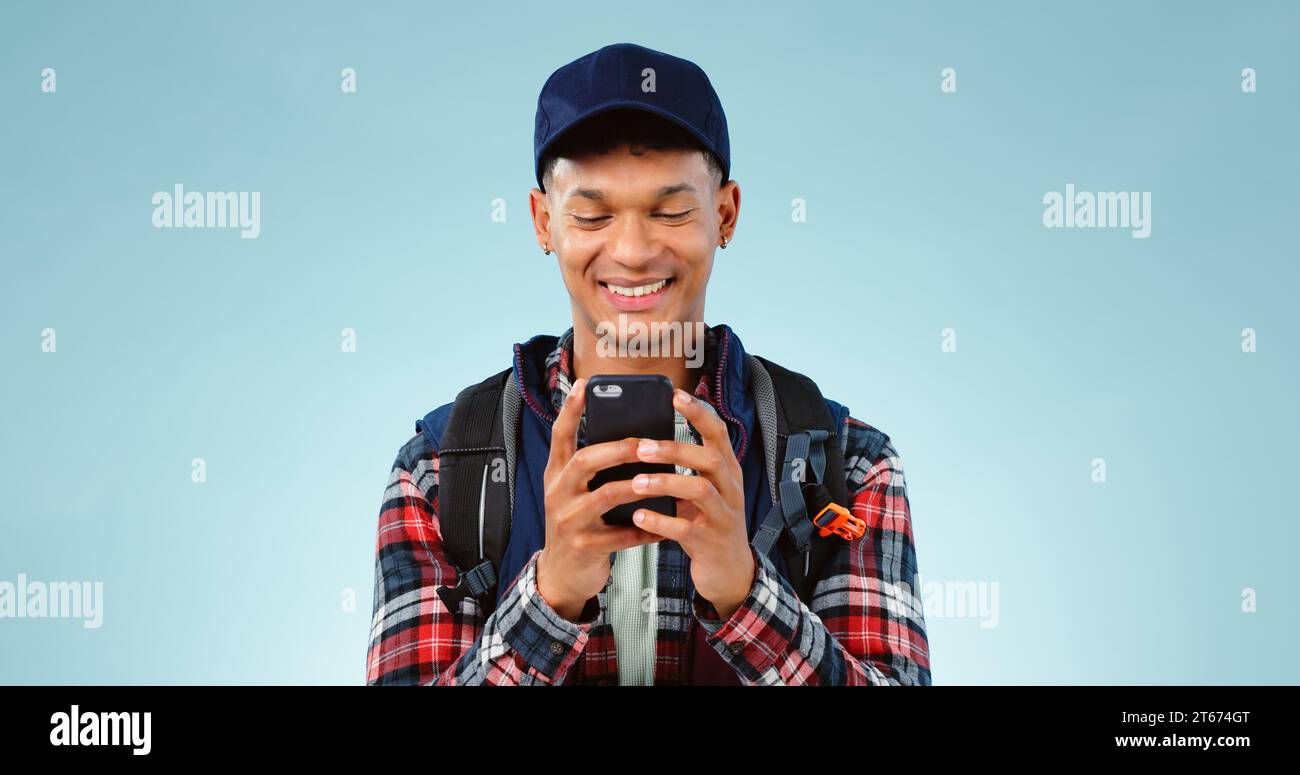 Hiking, smile and typing with man, smartphone and internet on a blue ...