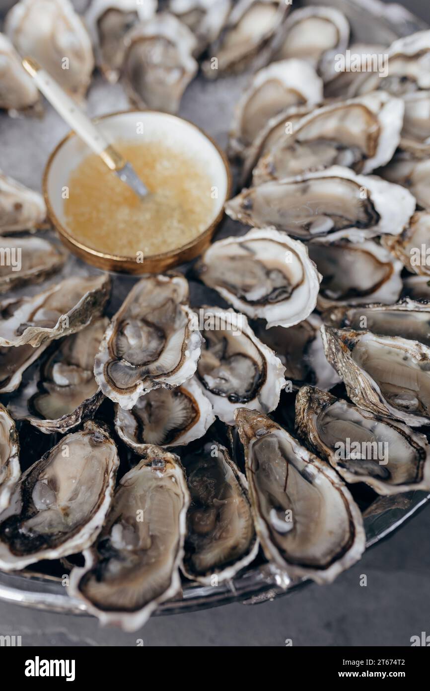 Gourmet food, delicacies. Fresh open oysters with sauce on buffet table ...