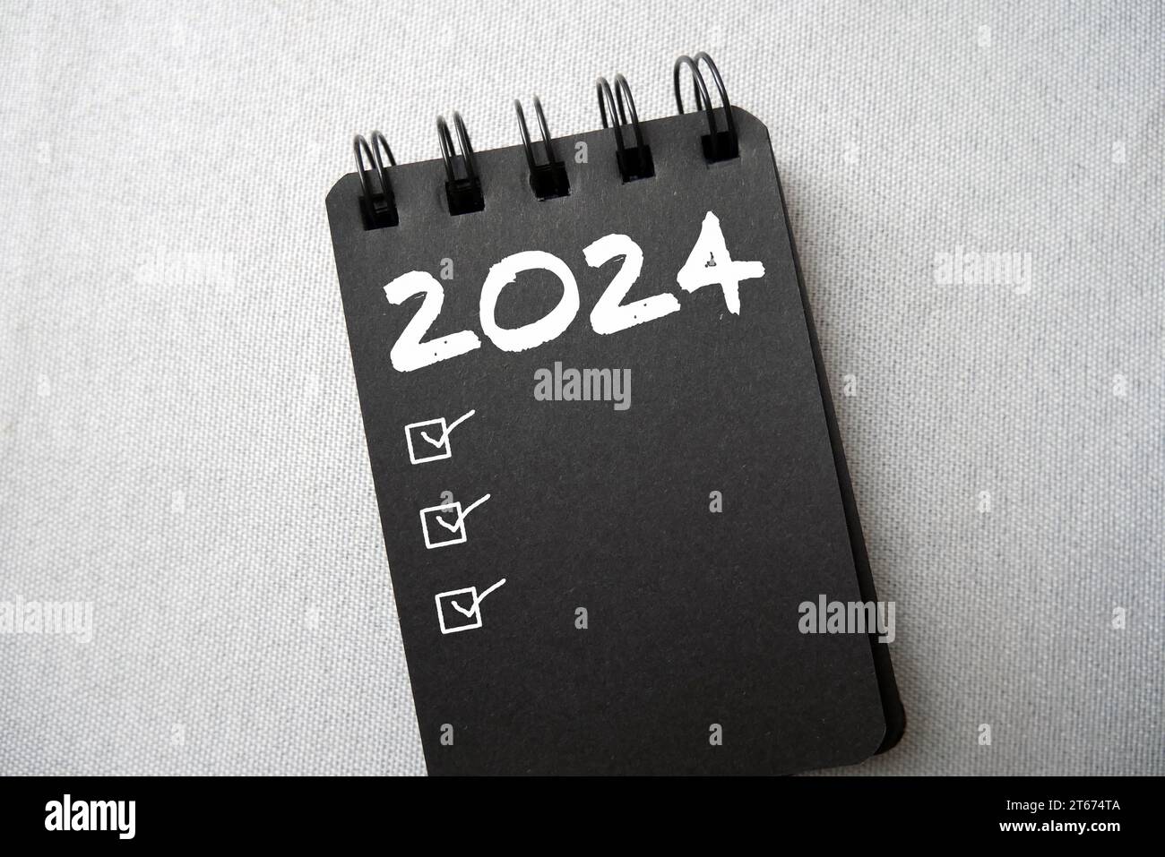 New year resolutions 2024 on black spiral notebook. 2024 goals list ...