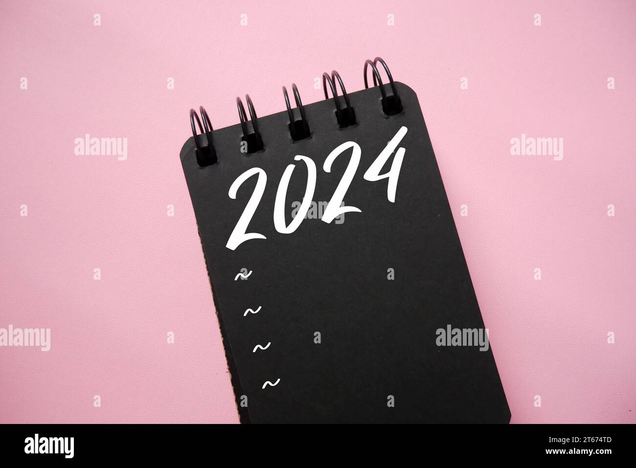 New year resolutions 2024 on black spiral notebook. 2024 goals list ...