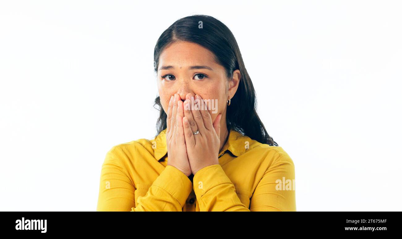 Wow, surprise and hands on face of woman in studio with bad news ...