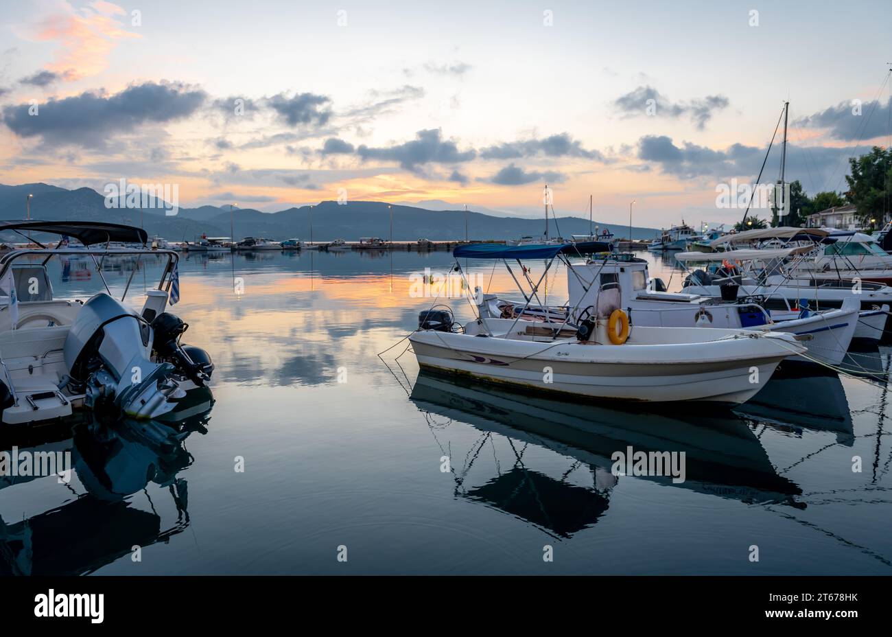 Sunrise sky cloud reflection on still sea harbour water with small ...