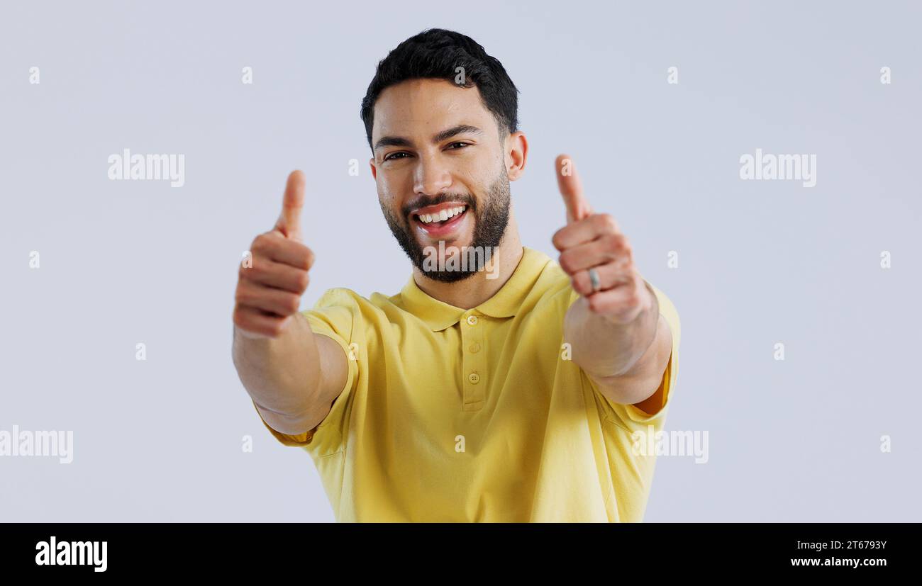 Thumbs up, portrait and man in studio for winner, achievement and ...
