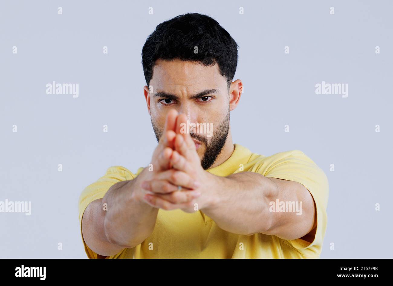 Finger gun, pointing and portrait of man in studio with aim for target ...