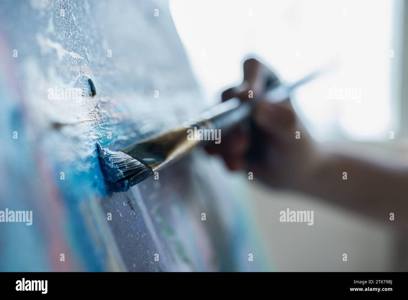 Female artist hold color palette and paintbrush for painting during ...
