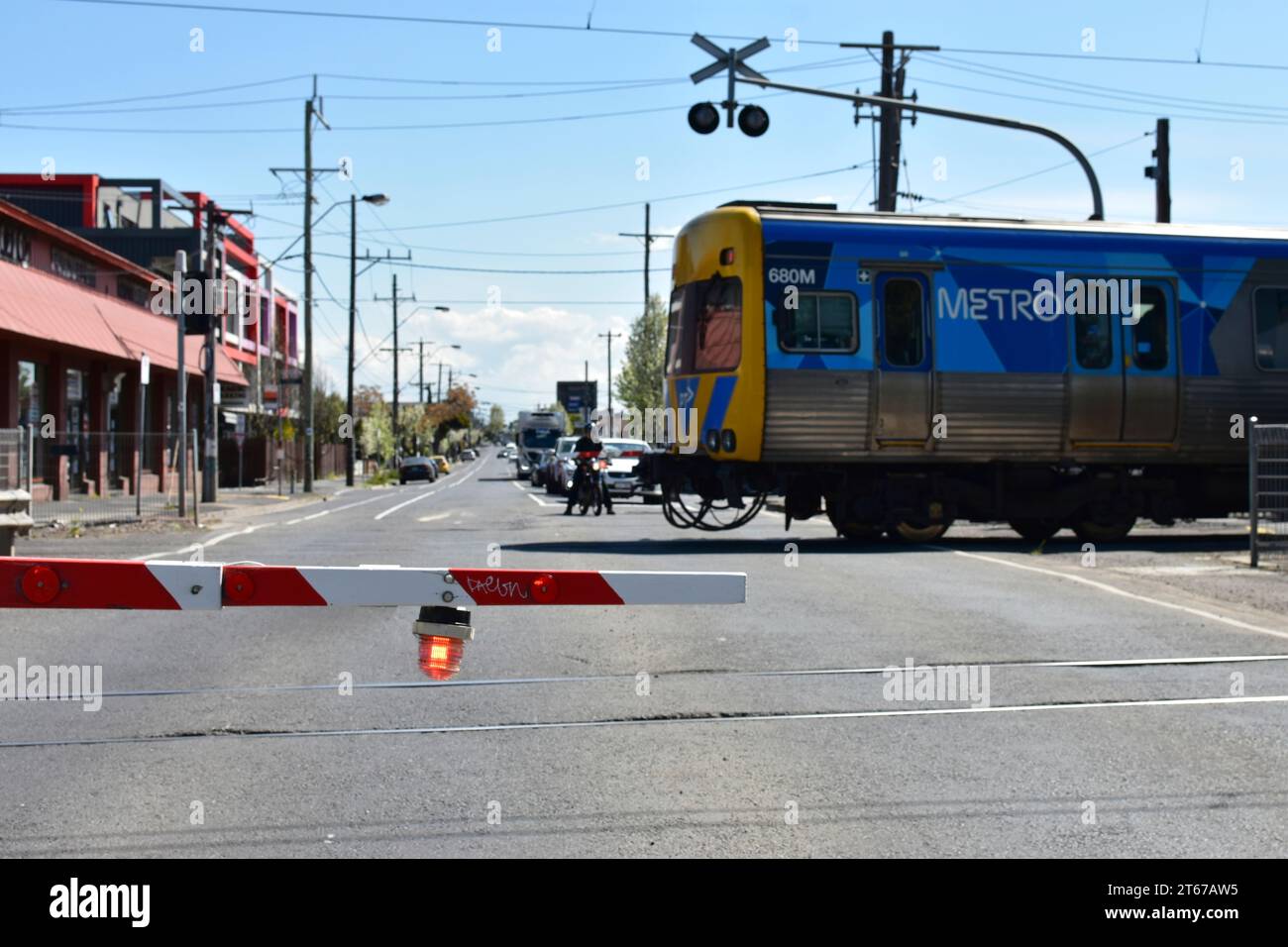 Melbourne, Victoria, Australia, 01012023: A Metro train crosses a level ...