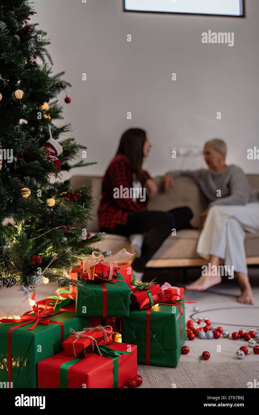 Beautiful Christmas gift boxes on floor near Christmas tree and have ...