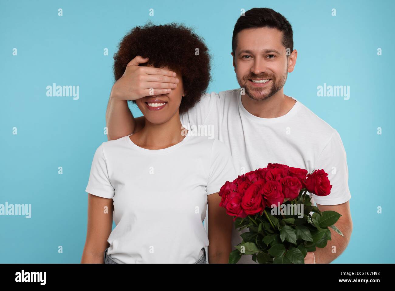 International dating. Handsome man presenting roses to his beloved ...